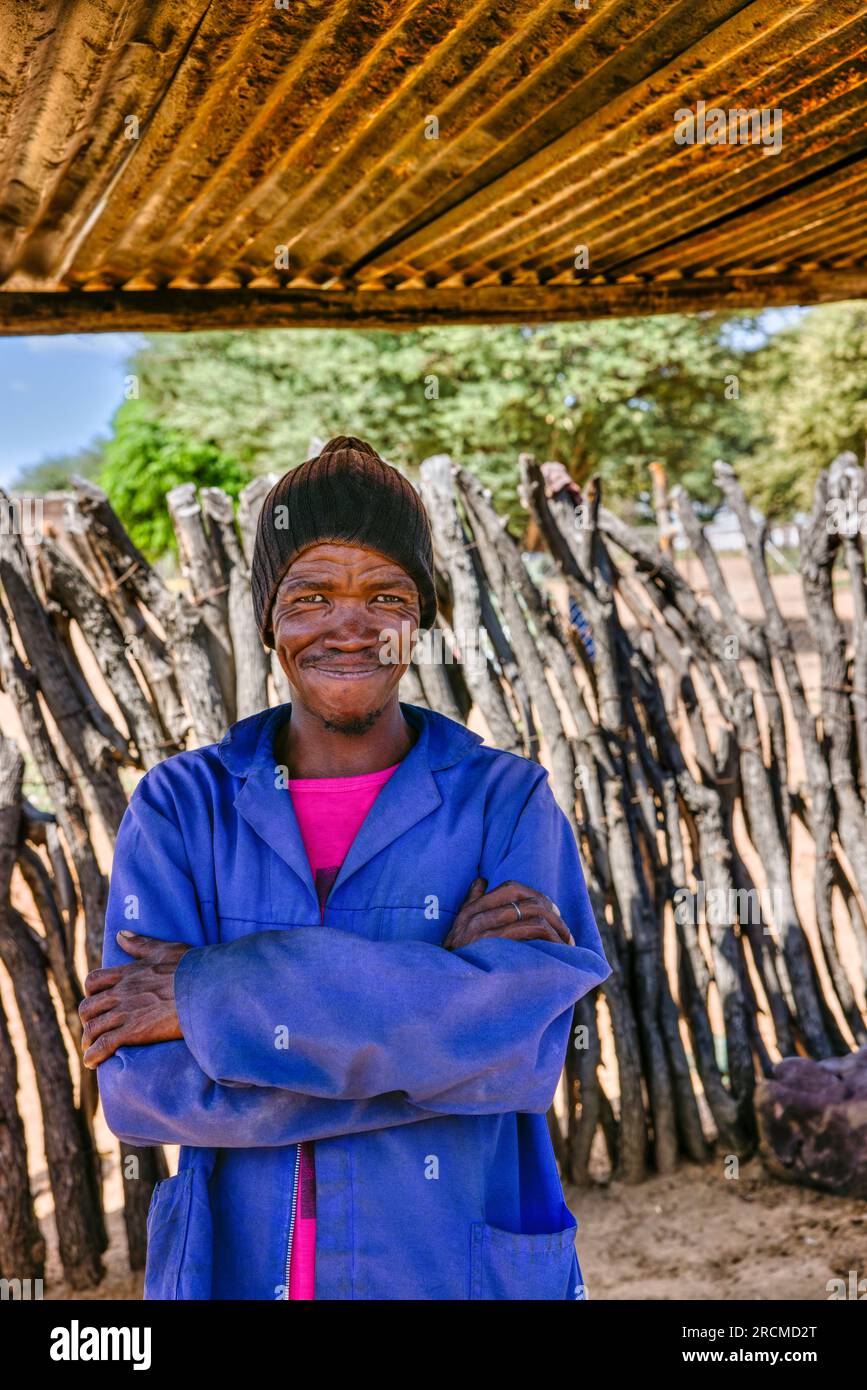 African village man standing in the yard, outdoors kitchen in rural ...