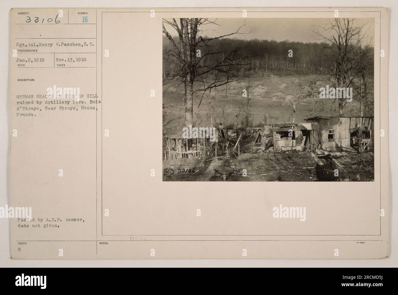 American soldier standing in front of destroyed German shacks on the ...