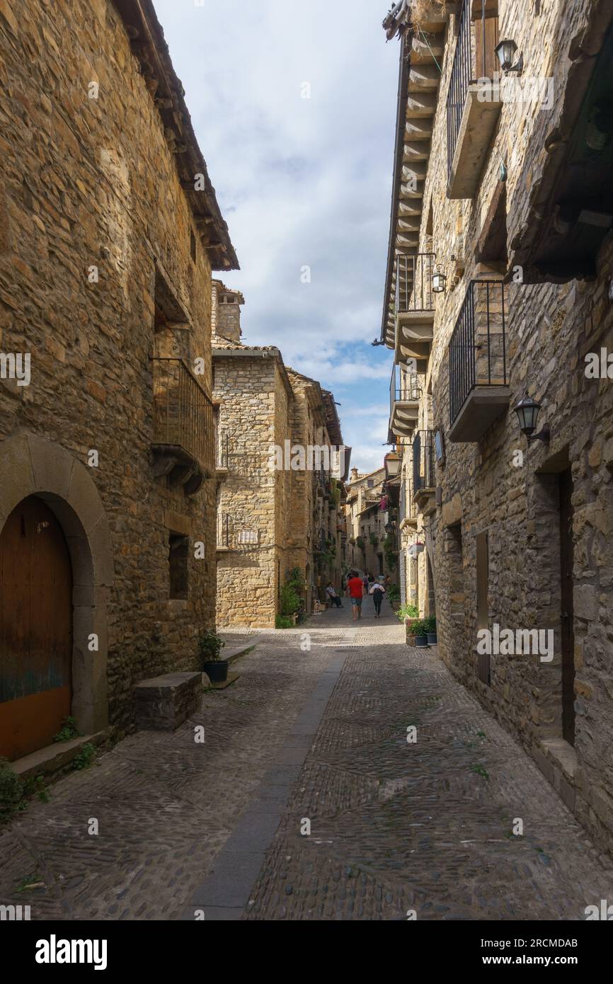 Street with stone houses in the medieval village of Ainsa in the ...