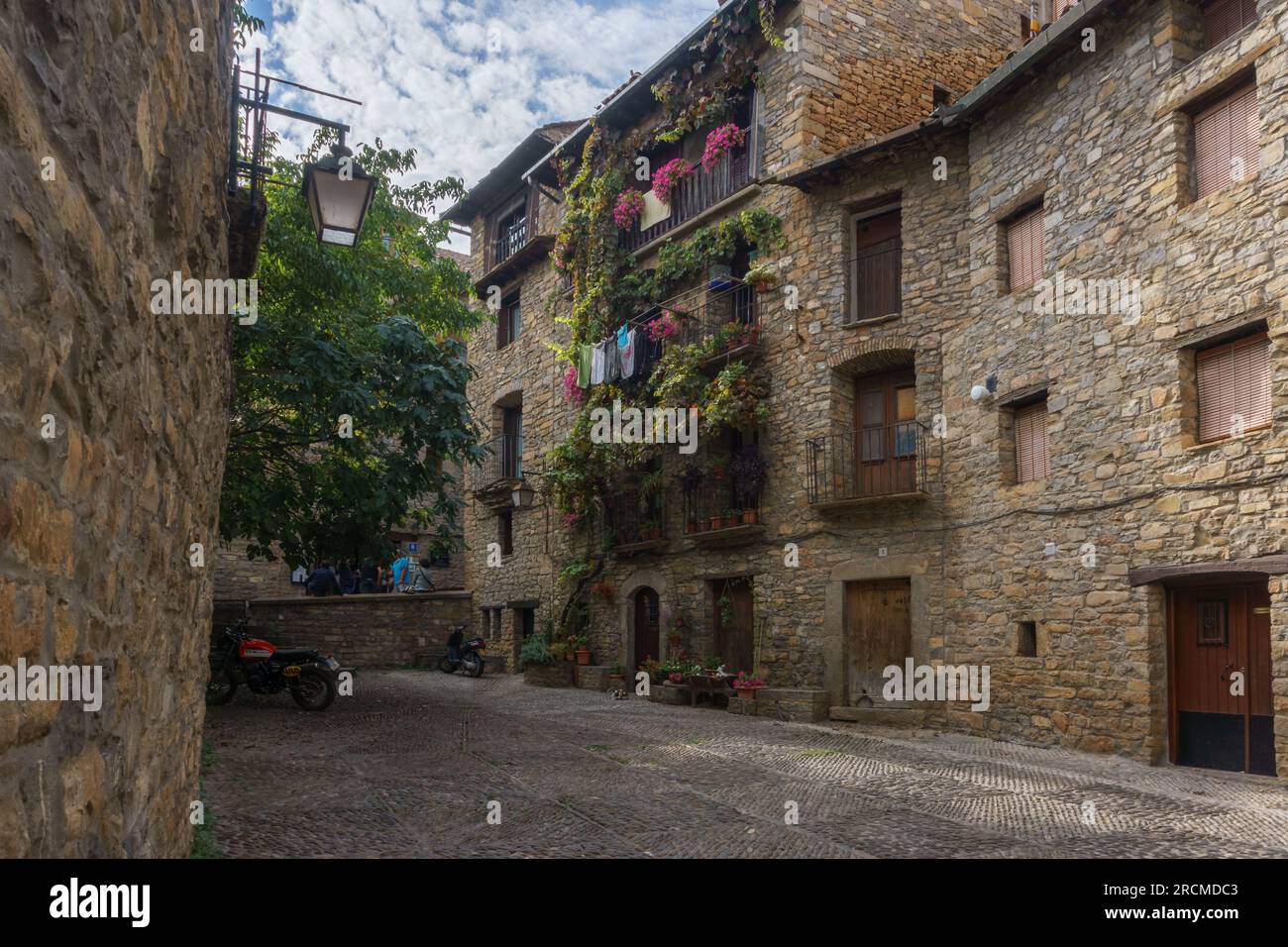 Street with stone houses in the medieval village of Ainsa in the ...