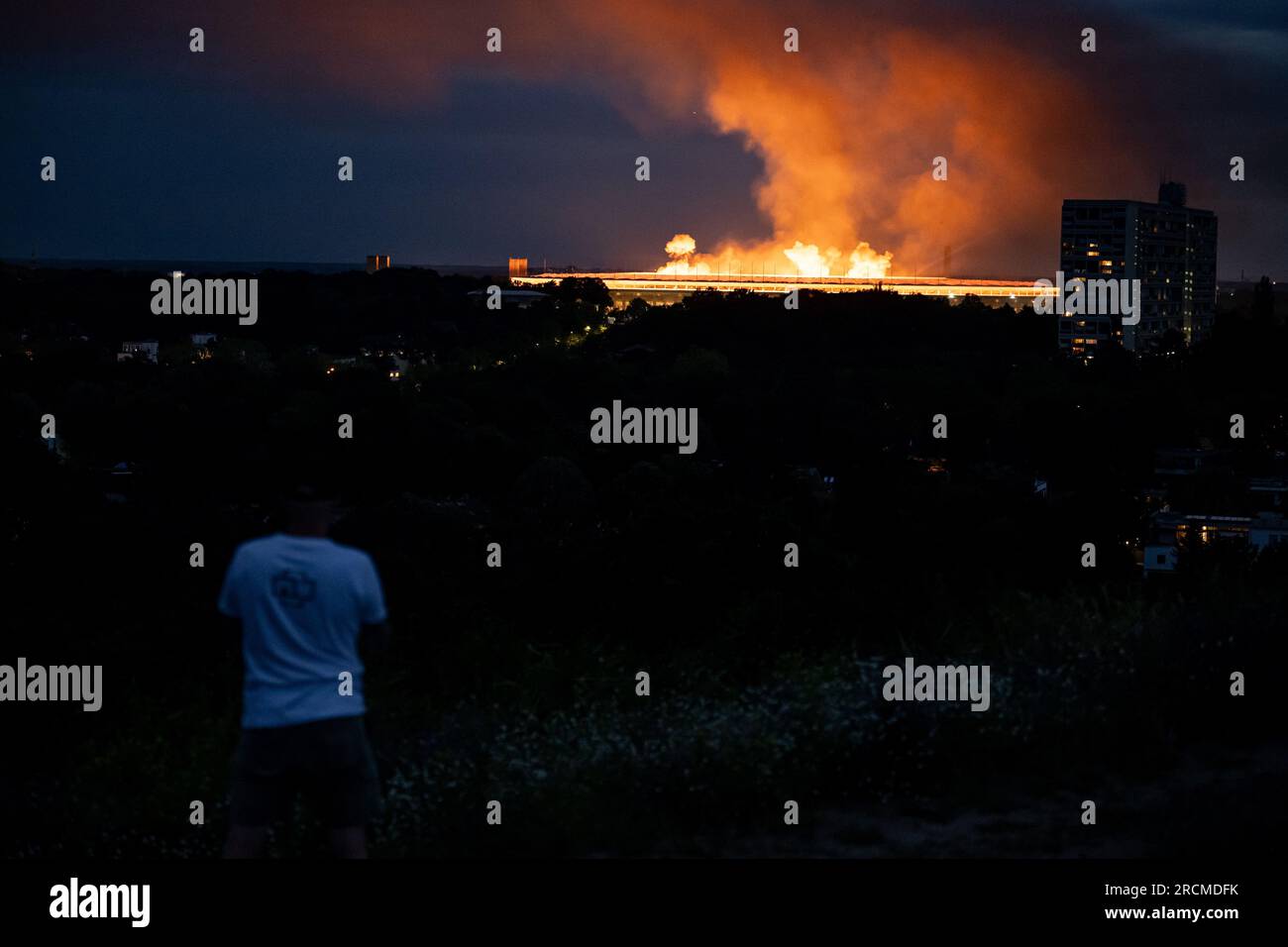 Berlin, Germany. 15th July, 2023. People watch the clouds of smoke over ...