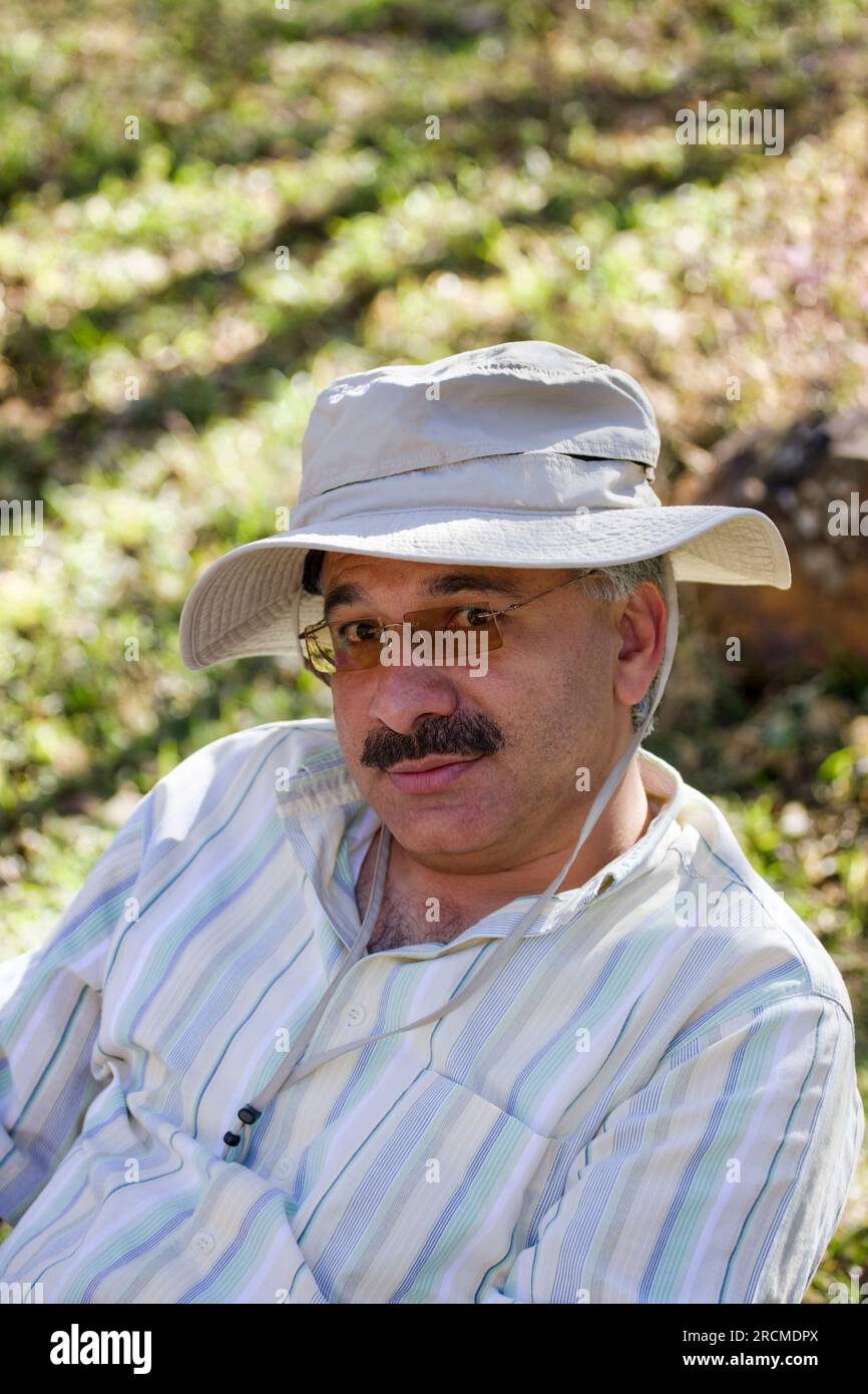 arabic man with a hat and a moustache enjoying an outing in the bush ...