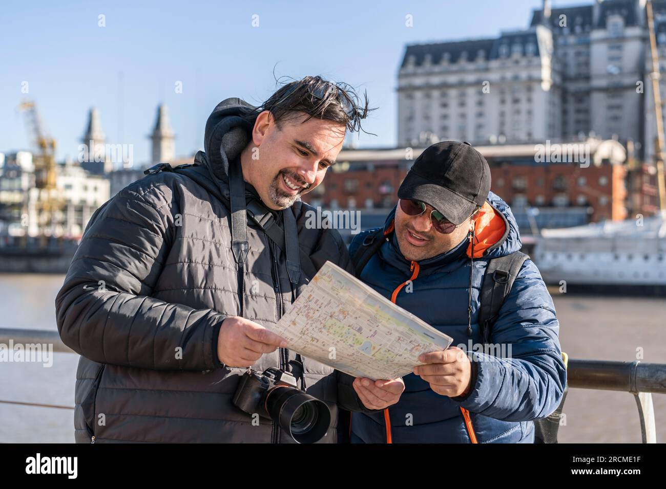 Travelers reading a map. LGBT couple. Travel friends Stock Photo - Alamy