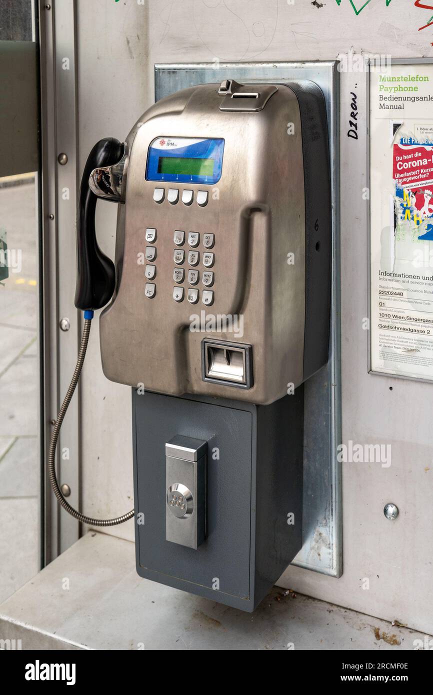 Vienna, AT - June 9, 2023 Vertical view of public payphone in downtown ...
