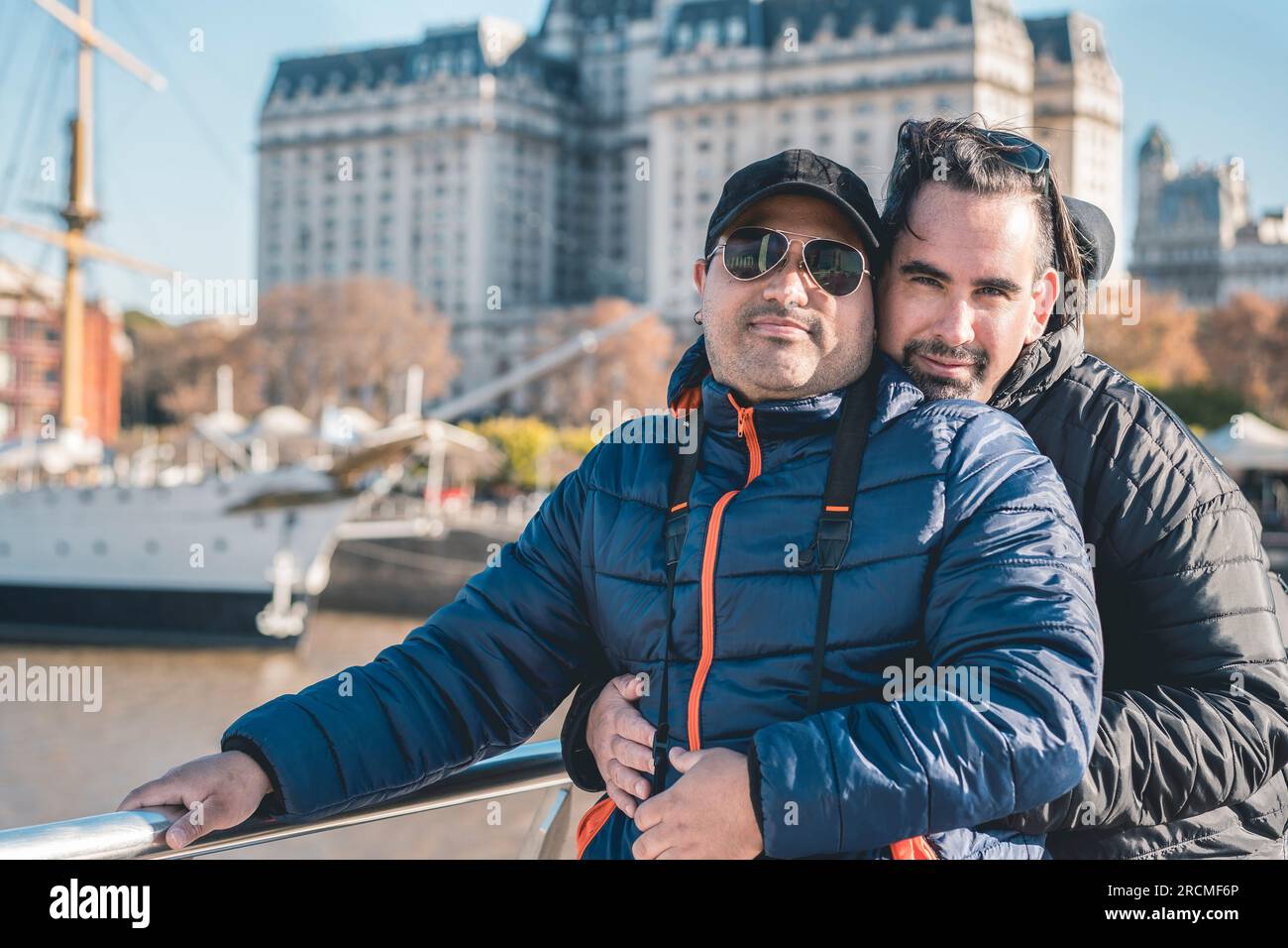 LGBT gay couple hugging each other while looking at camera Stock Photo ...