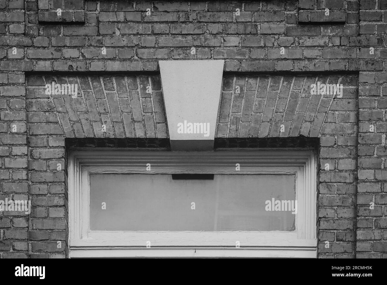 Old transom window and solid brick in monochrome Stock Photo - Alamy