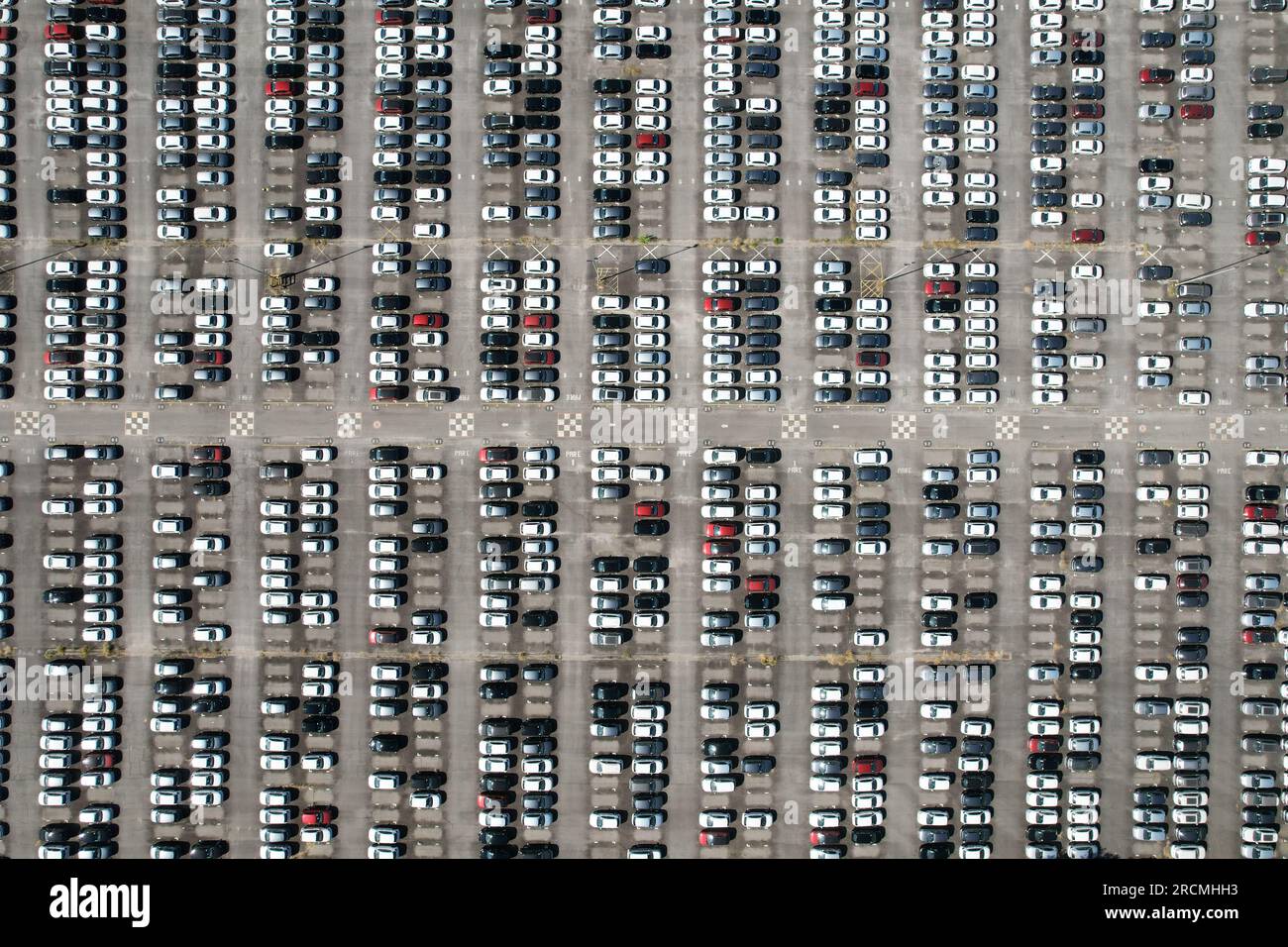 Aerial view of new cars stock at factory parking crowded lot ...
