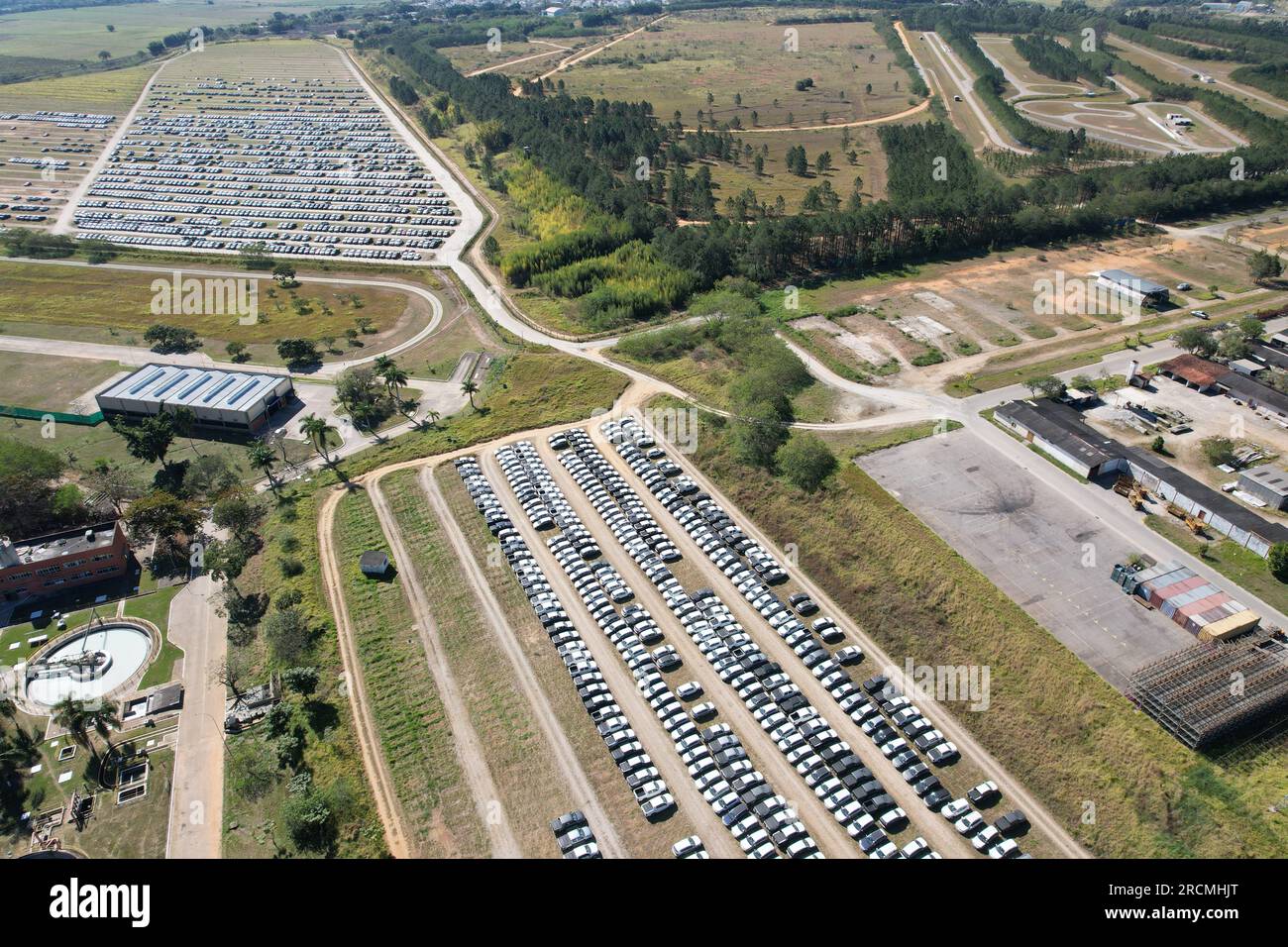 Aerial view of new cars stock at factory parking crowded lot ...