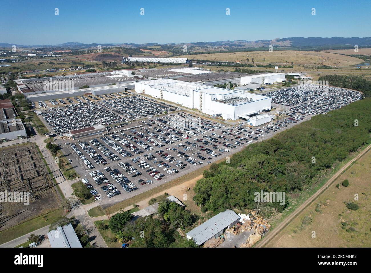 Aerial view of new cars stock at factory parking crowded lot ...