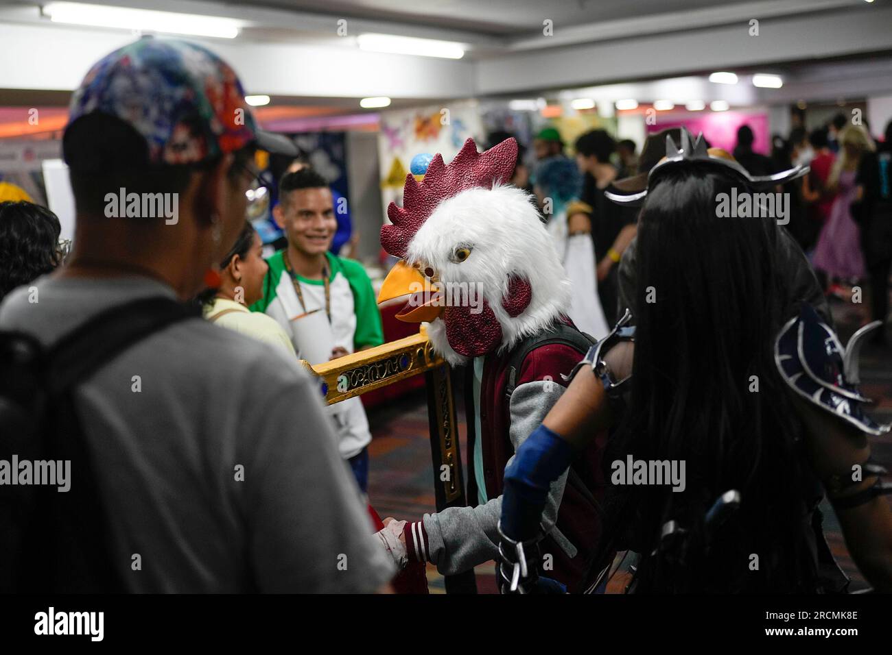 A cosplayer dressed in a chicken character costume attends the Comic ...