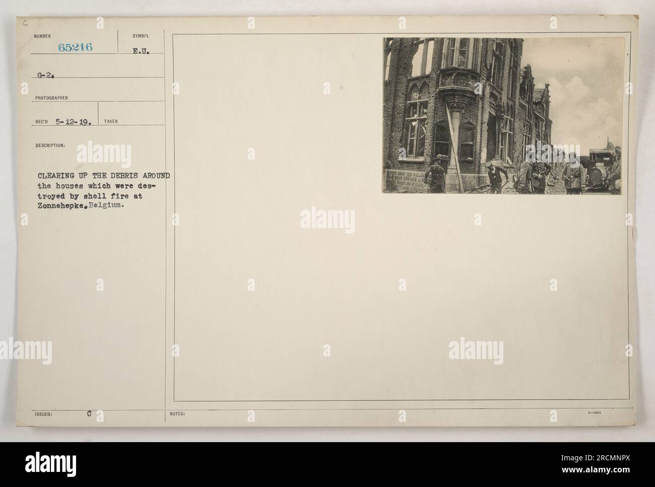 American soldiers clearing debris around houses destroyed by shell fire ...