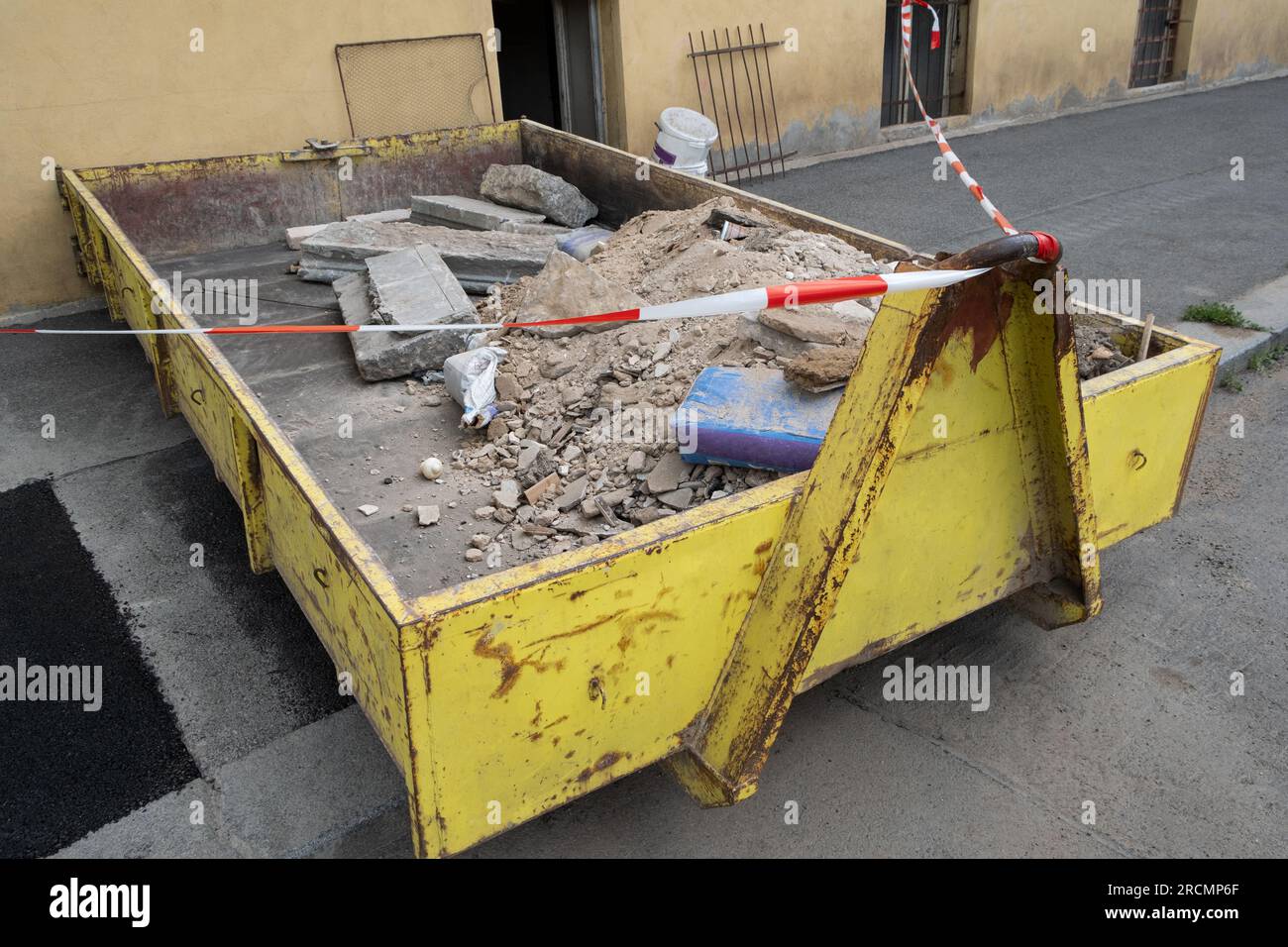 metal dumpster waste container filled with construction waste, rubble ...