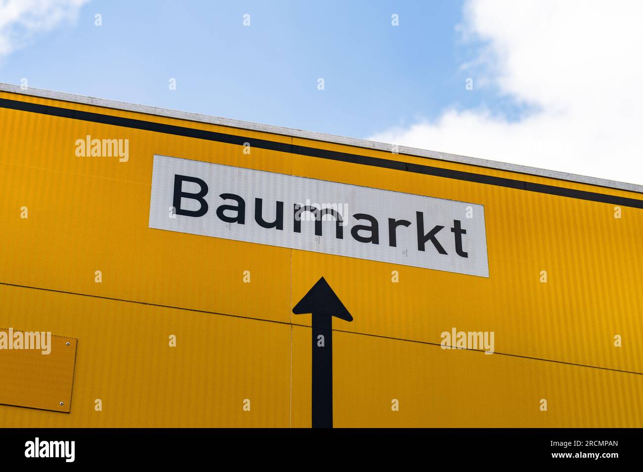 Street sign with an arrow to a "Baumarkt" indicating that the hardware ...