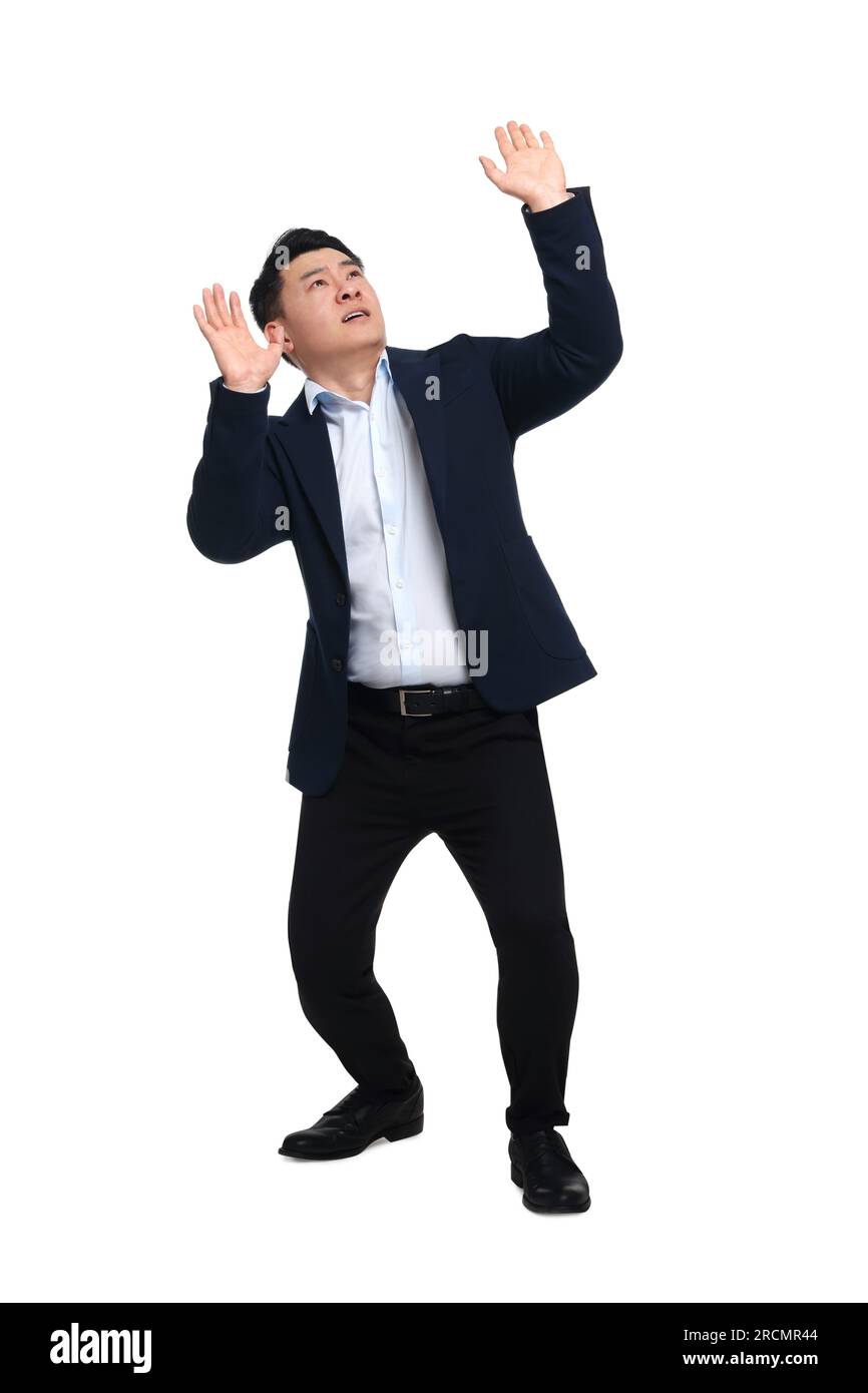Scared businessman in suit posing on white background Stock Photo - Alamy