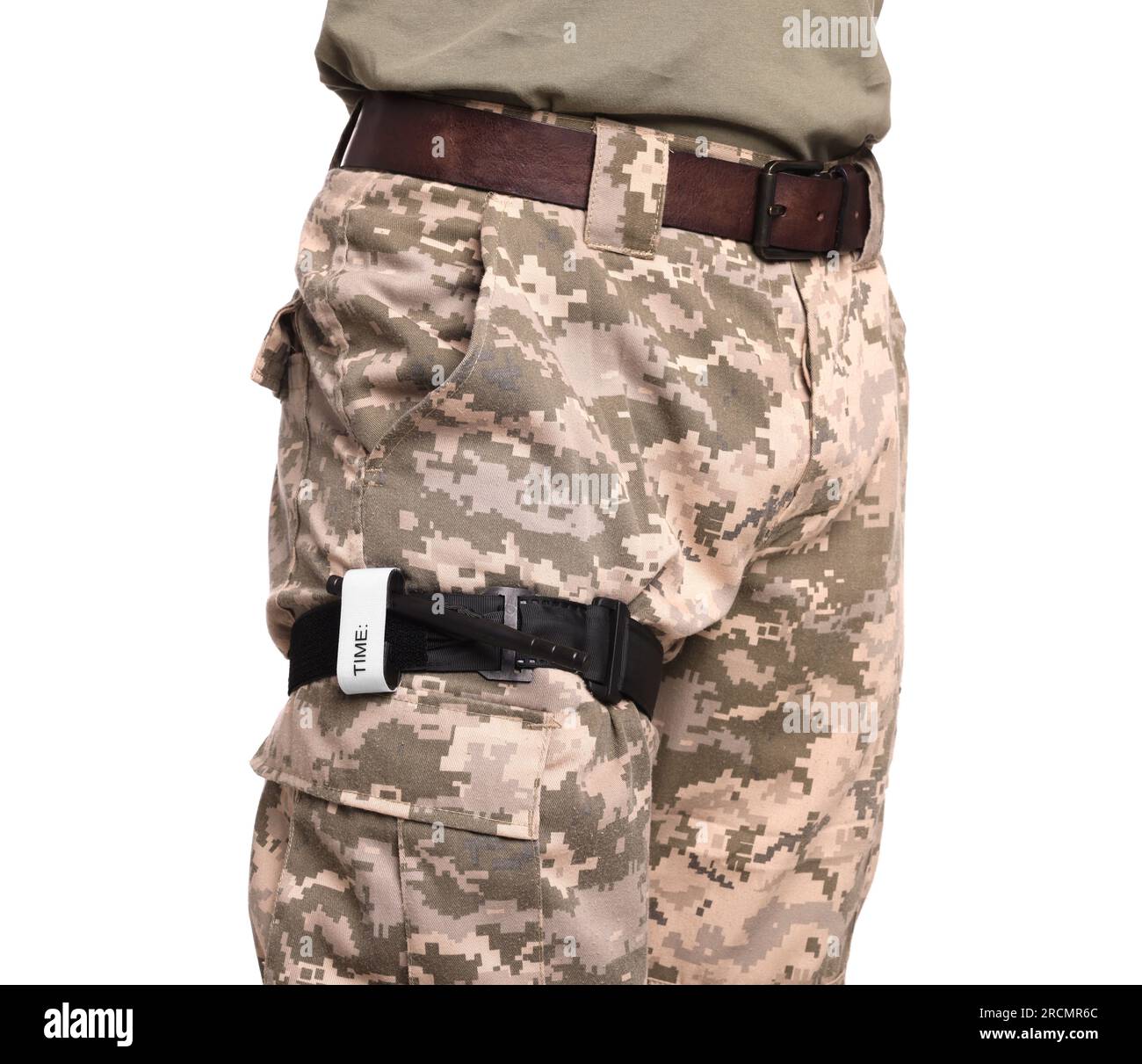 Soldier in military uniform with medical tourniquet on leg against ...