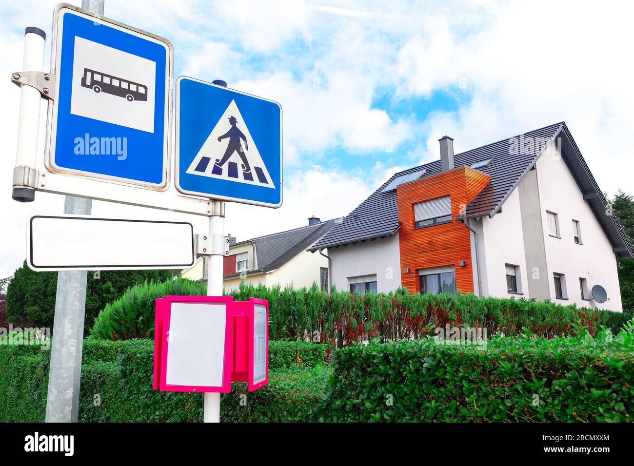 Road signs and modern houses with blue sky background. Concept of real ...