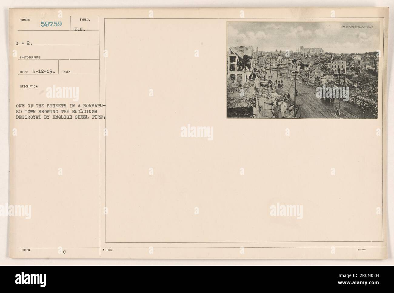 This image depicts a street in a town that has been damaged by English ...