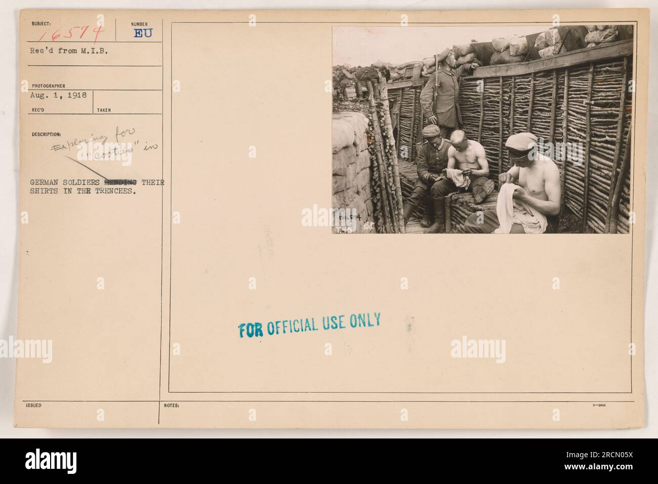 American soldier searching for lice in German soldiers' clothing in the ...