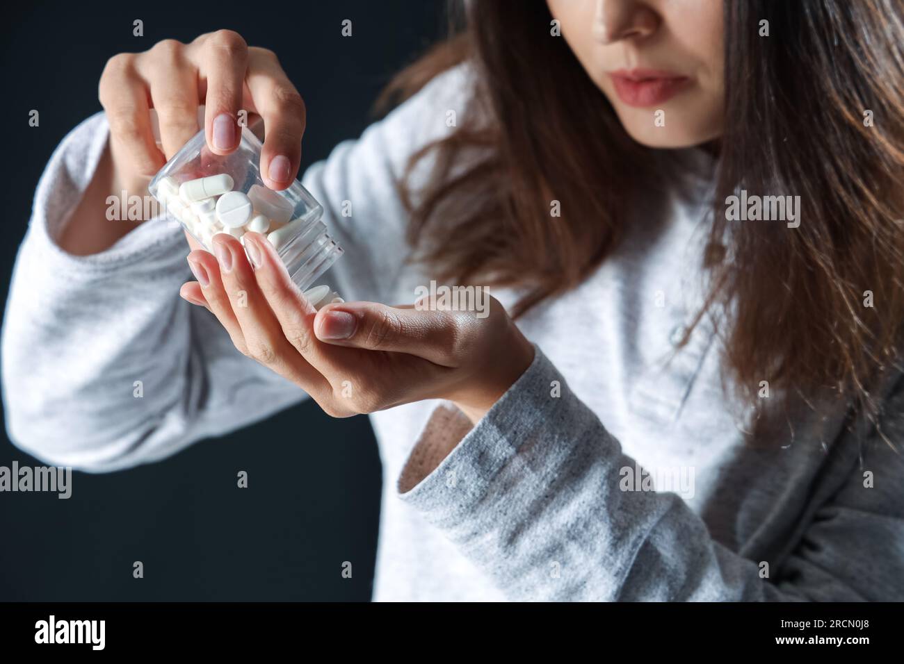 Female drug addict taking pills on black background, closeup Stock ...