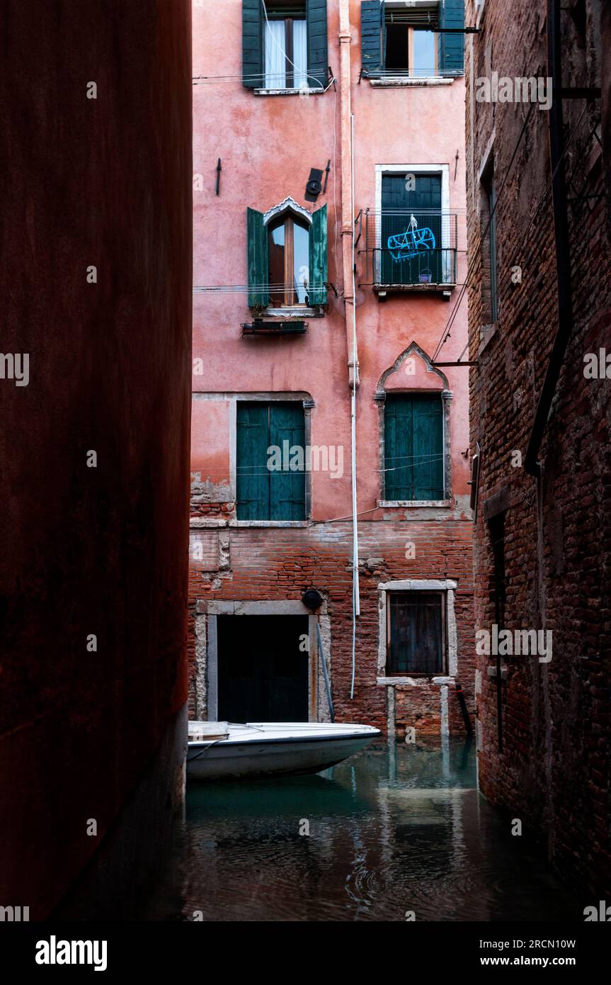 Square windows and ogee arch on a narrow canal in Venice, Italy Stock ...