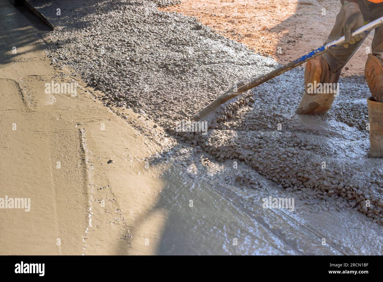 Workers in construction site with slump concrete ready mix trowel ...