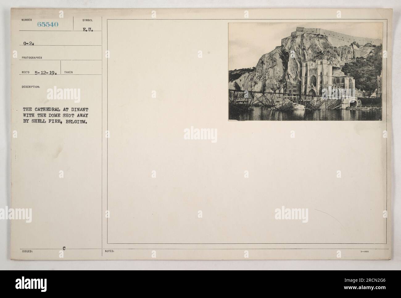 The photograph shows the damaged cathedral at Dinant, Belgium during ...