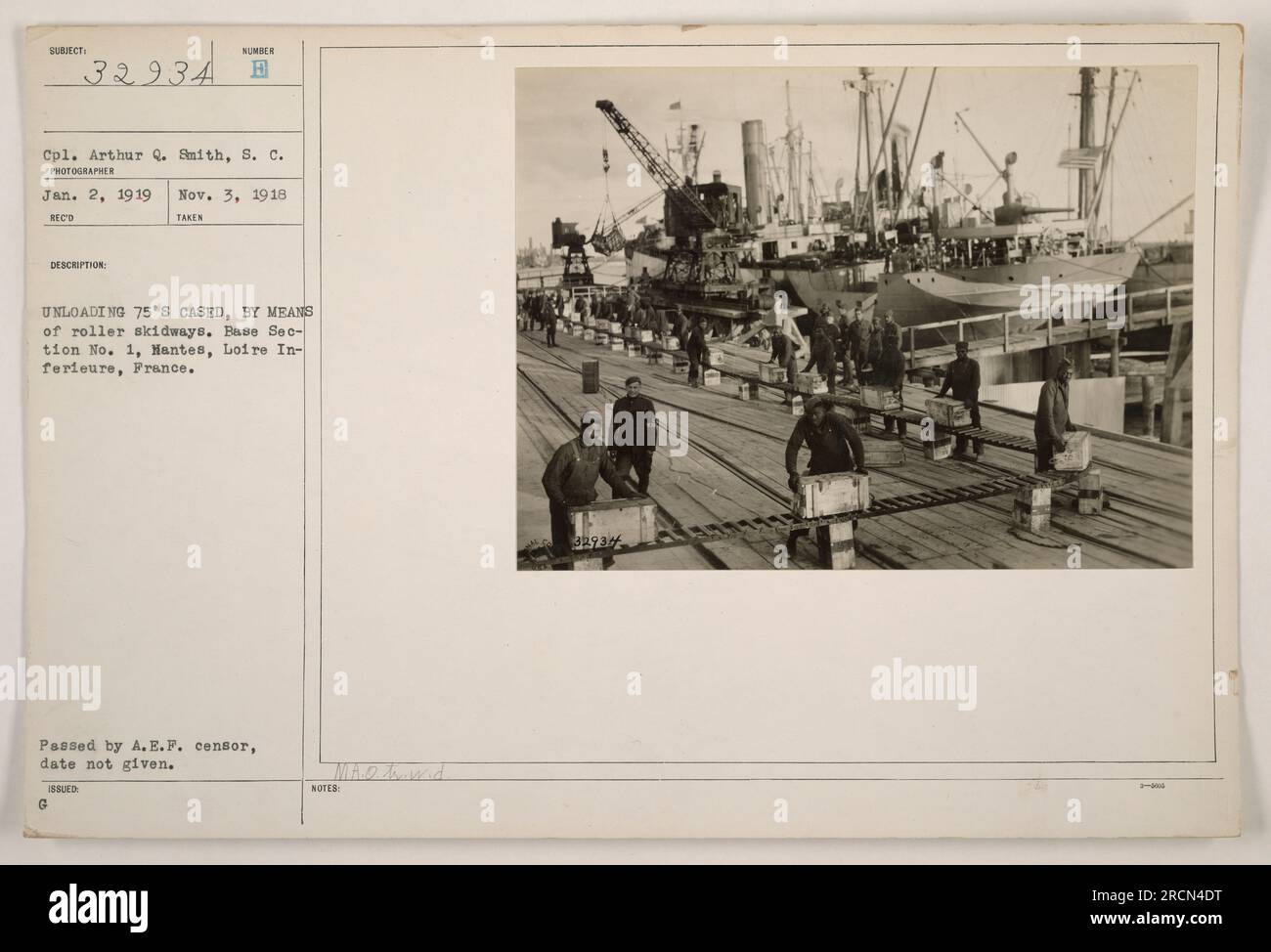 Corporal Arthur Q. Smith of the Signal Corps unloading 75mm artillery ...