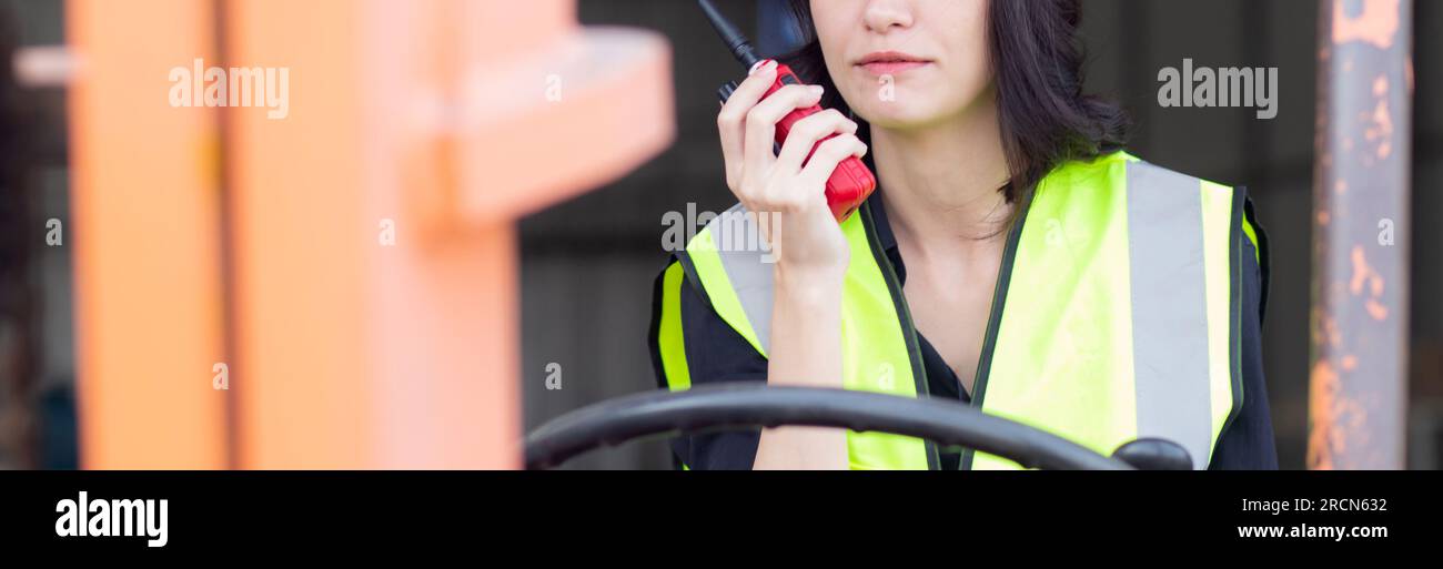 Young asian woman is foreman using radio for communication while ...