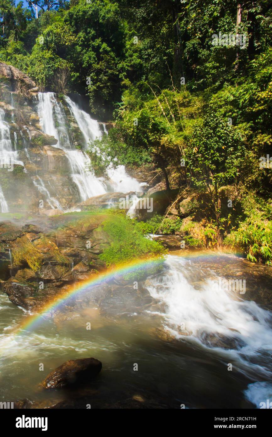 A colorful rainbow in front of a waterfall on a rainy day. Doi Inthanon ...