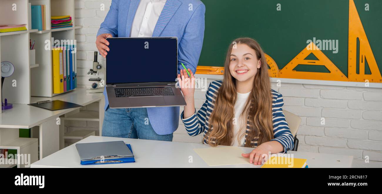 happy child with school teacher presenting laptop screen with copy ...