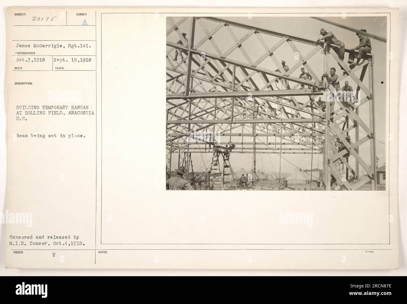 Construction workers setting a beam in place during the building of a ...