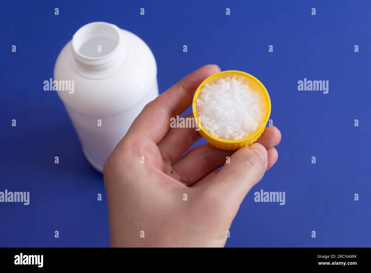 Closeup White Plastic Bottle, Cap Filled With Pipe Cleaner Granules In ...