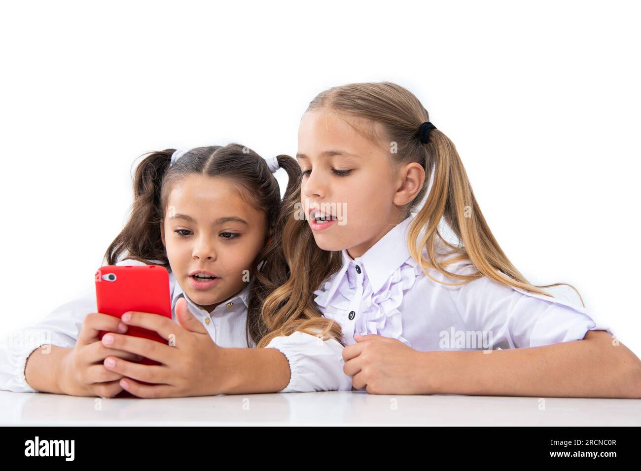 school children messaging. two girls messaging on phone. girls children ...