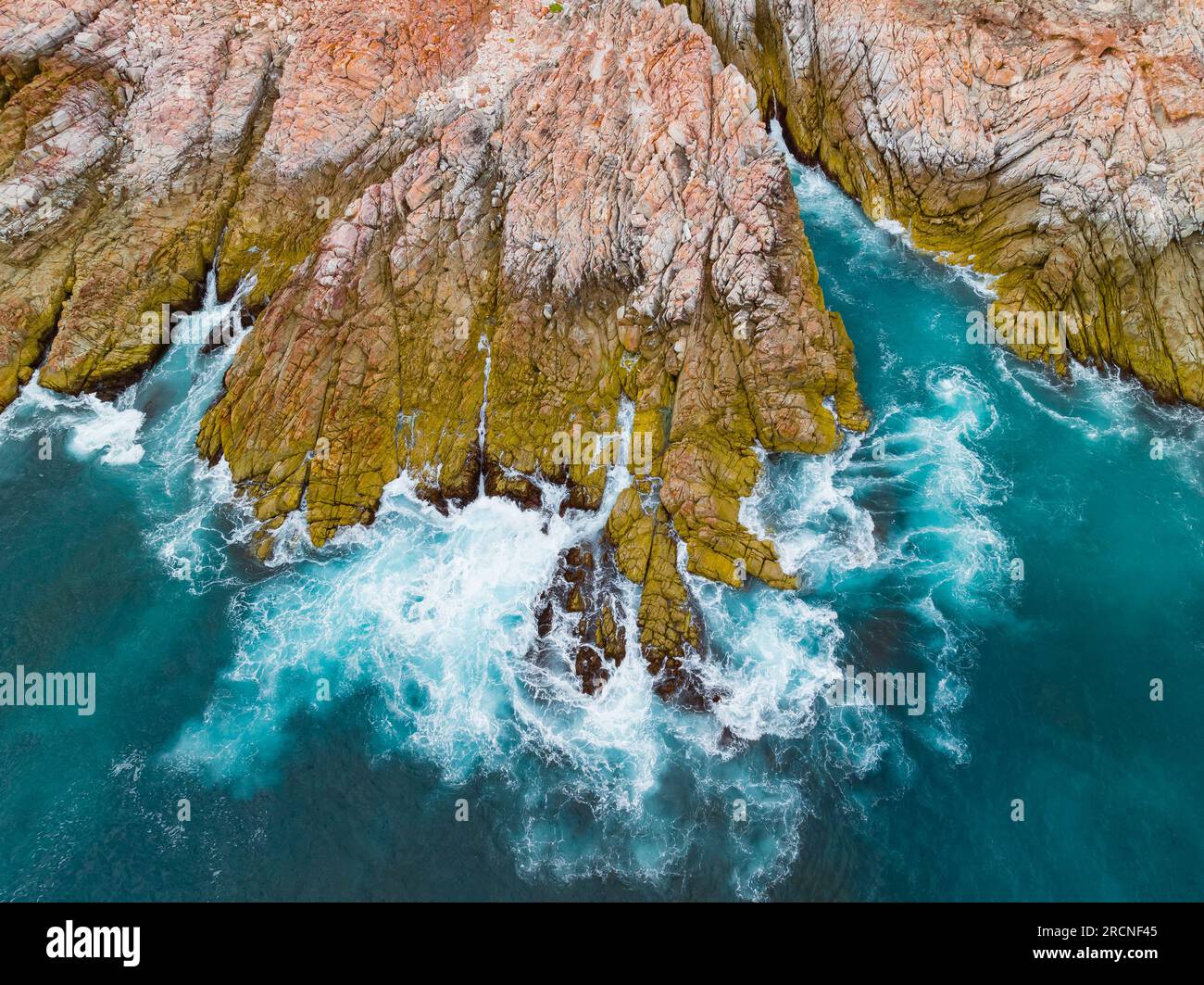Aerial view of waves crashing onto a rugged eroded coastline at Coles ...