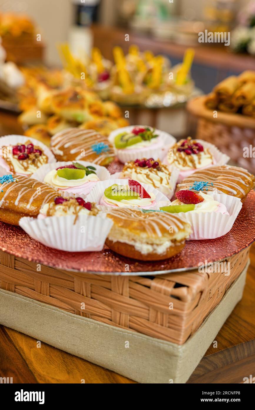 doughnuts and fruit tarts with wiped cream and glazed with chocolate ...