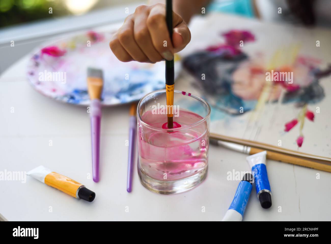 Woman dipping brush water palette hi-res stock photography and images ...