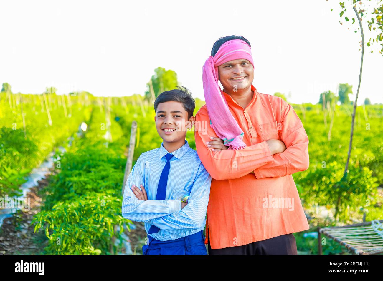 Cute indian farmer child in school uniform with his father at ...