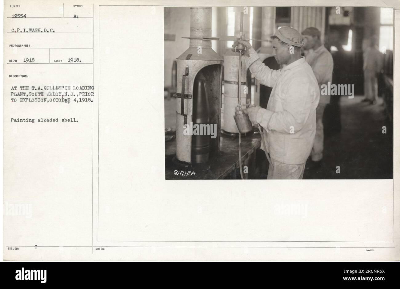 Soldier in World War I painting a loaded shell at the T.A. Gillespie ...