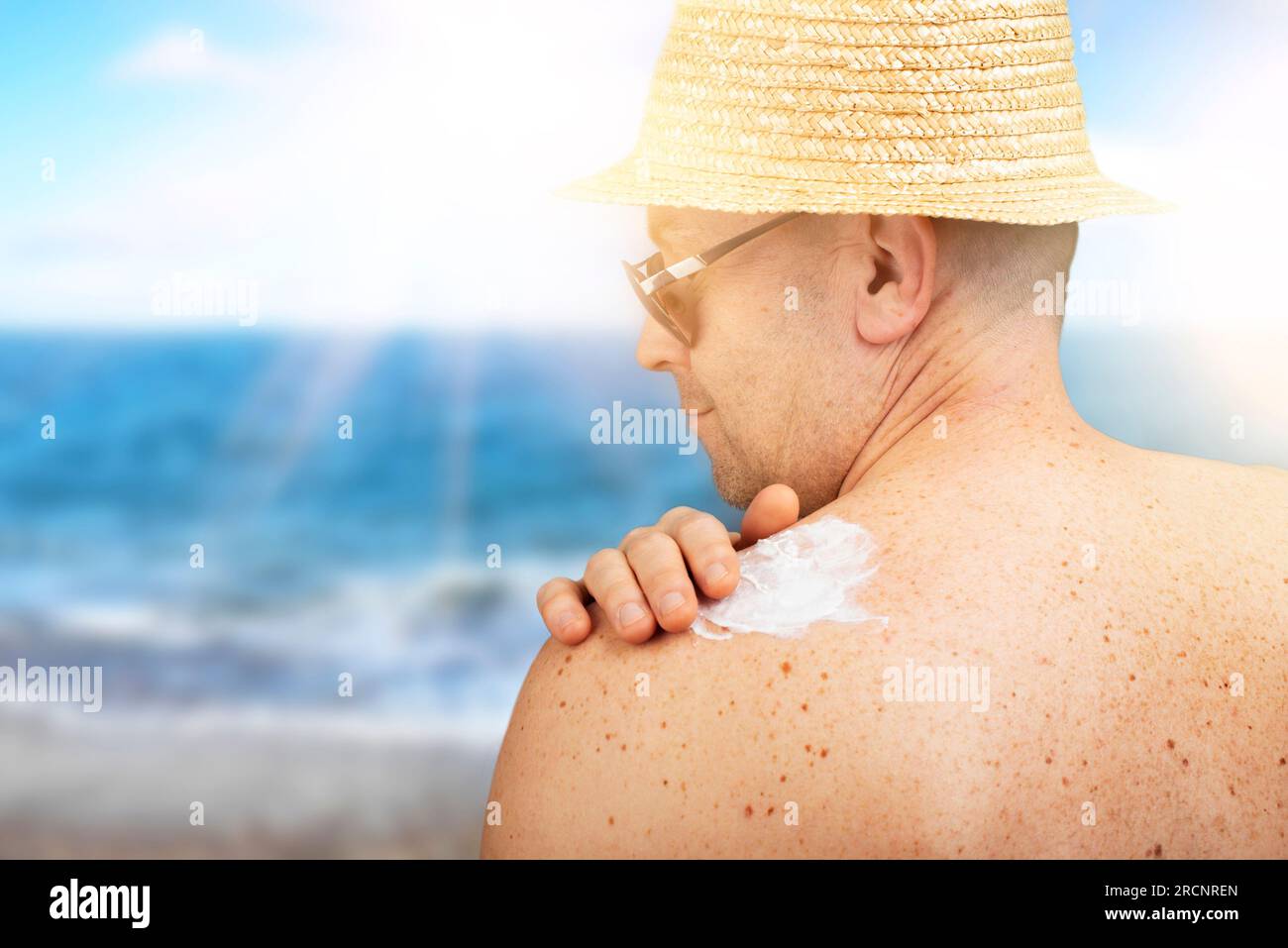 Middle aged caucasian male model applying sunscreen Stock Photo - Alamy