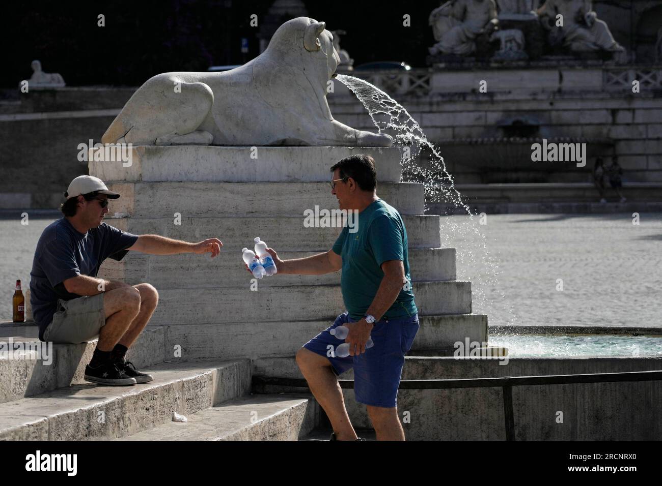 Tourists pass each other bottles of cold water in Rome, Sunday, July 16 ...