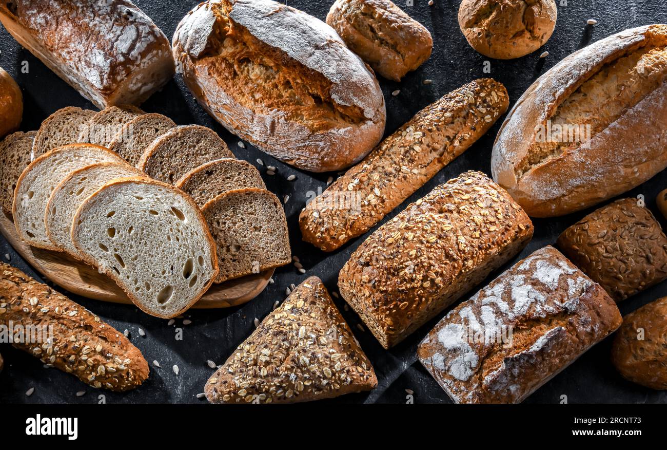 Assorted bakery products including loafs of bread and rolls Stock Photo ...