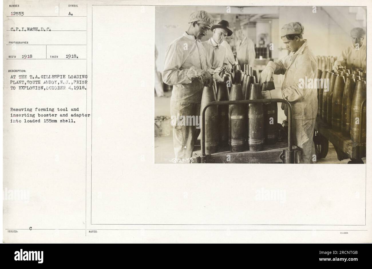 American military personnel working on loading an explosive shell at ...