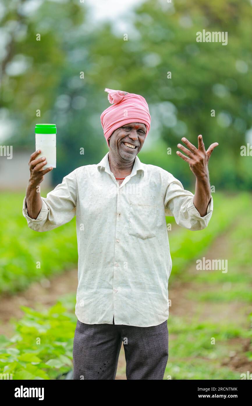 Indian happy farmer holding empty Bottle in hands, happy farmer showing ... Indian happy farmer holding empty Bottle in hands, happy farmer showing ...