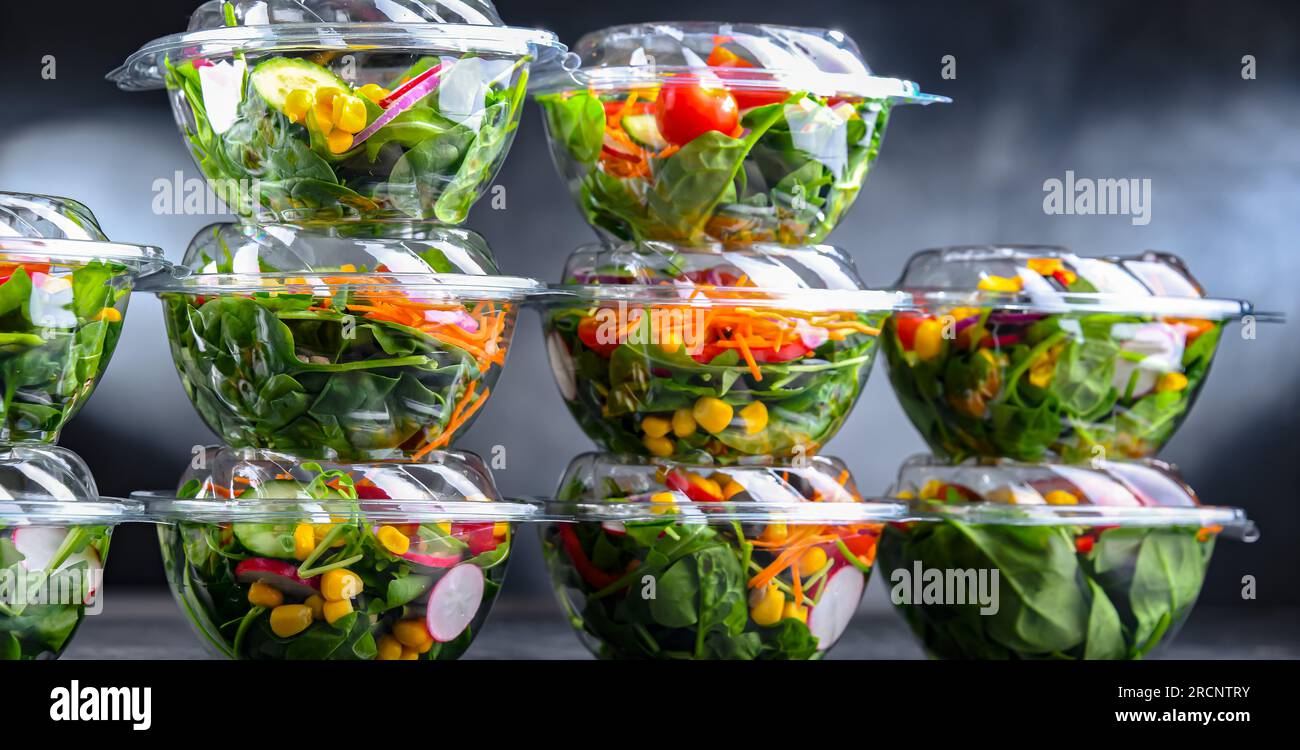 Plastic boxes with pre-packaged vegetable salads, put up for sale in a ...