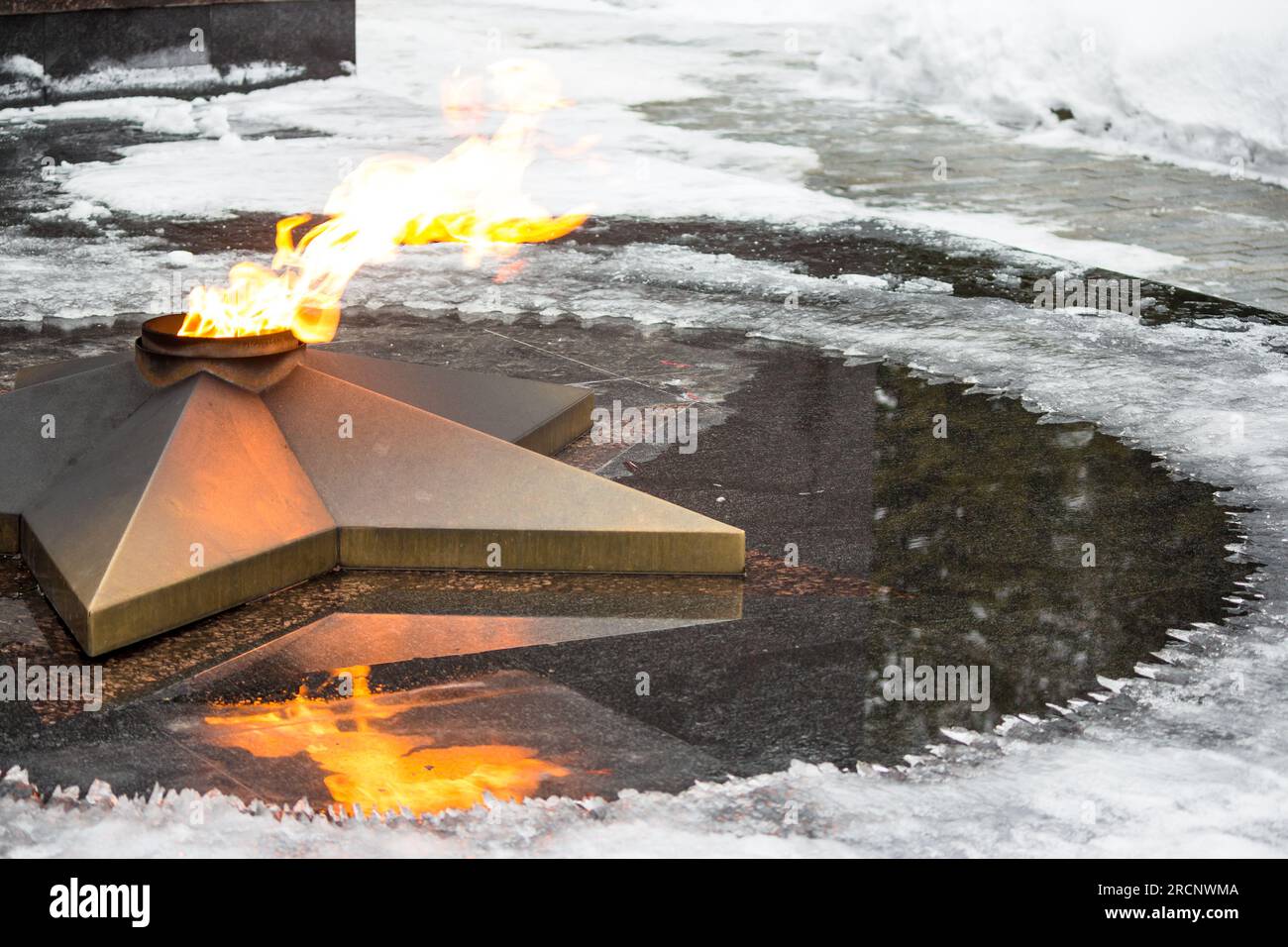 Flame from the Eternal Flame melts the ice around. Memorial of the ...