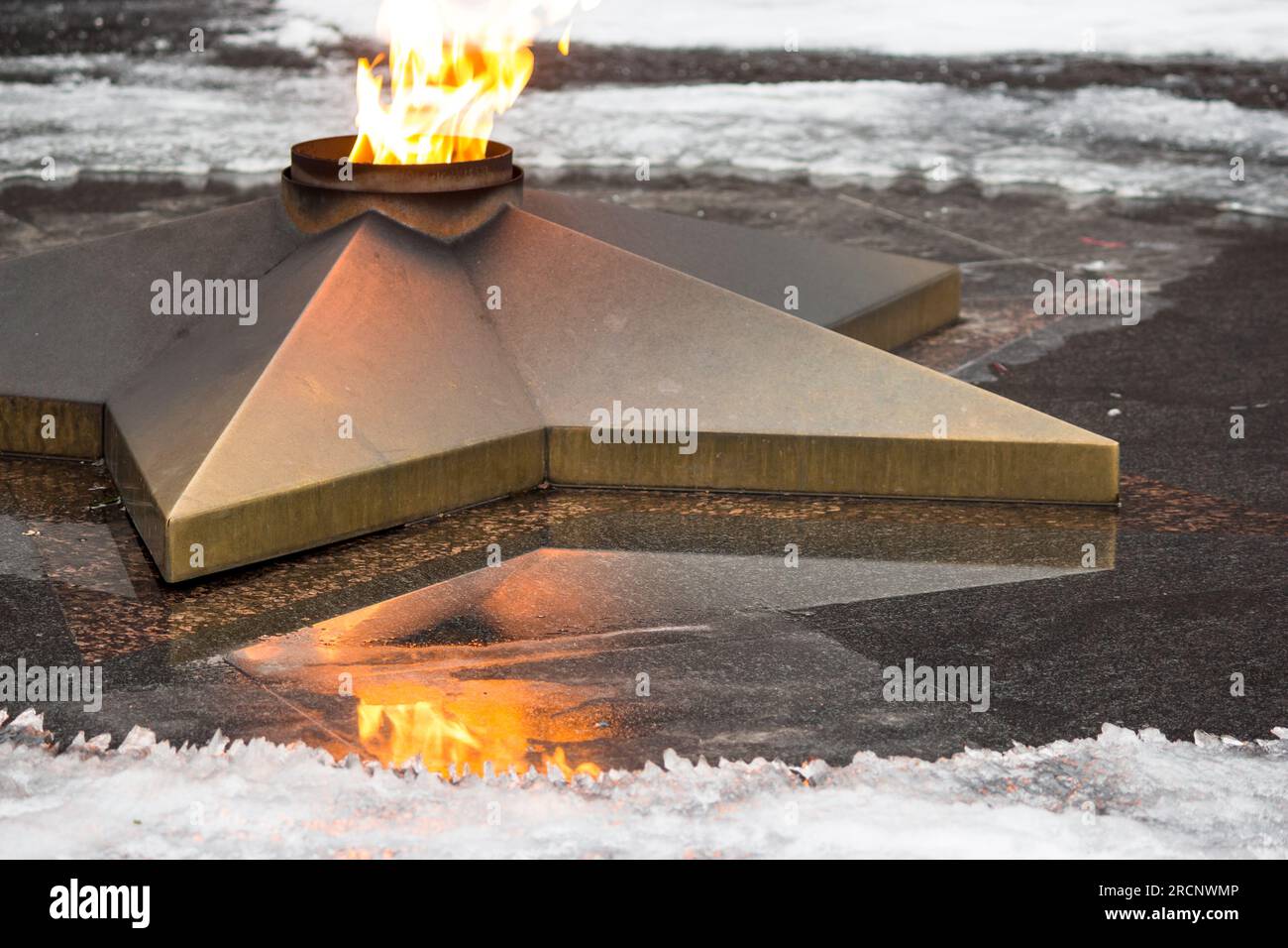 Flame from the Eternal Flame melts the ice around. Memorial of the ...