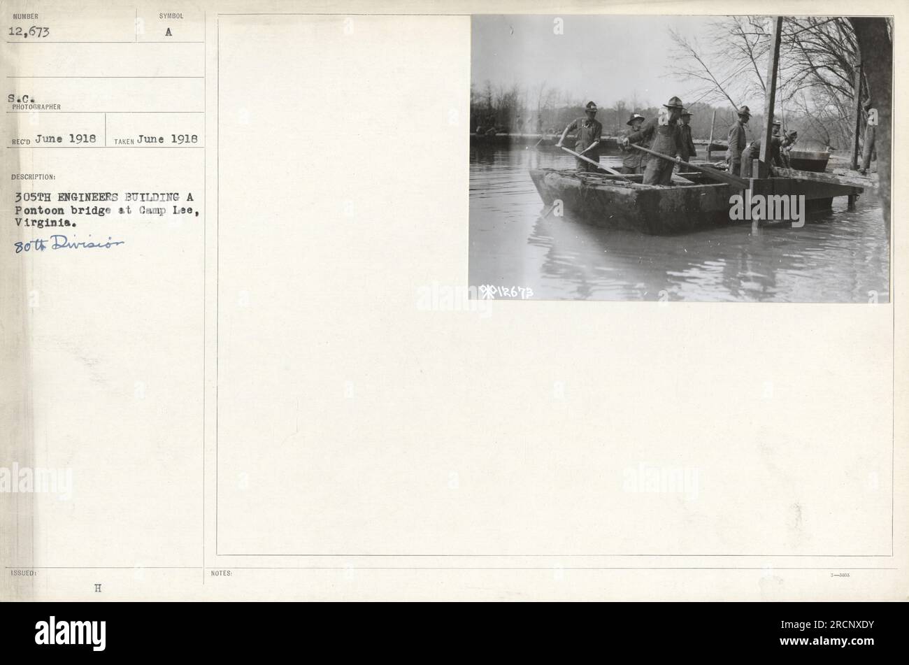 Soldiers from the 305th Engineers building a pontoon bridge at Camp Lee ...