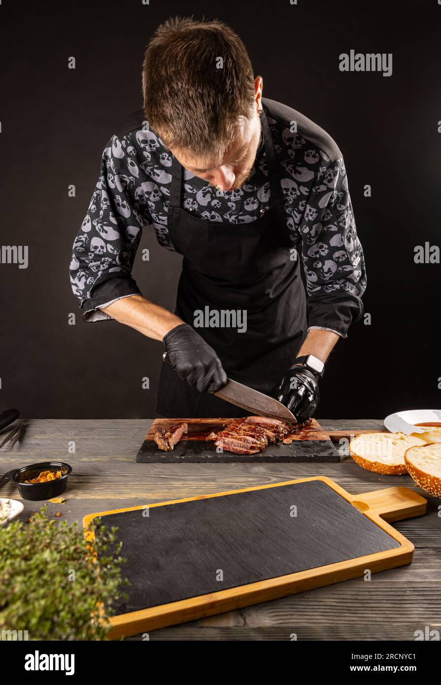 Juicy freshly grilled steak. Chef cuts fried meat to slices Stock Photo ...