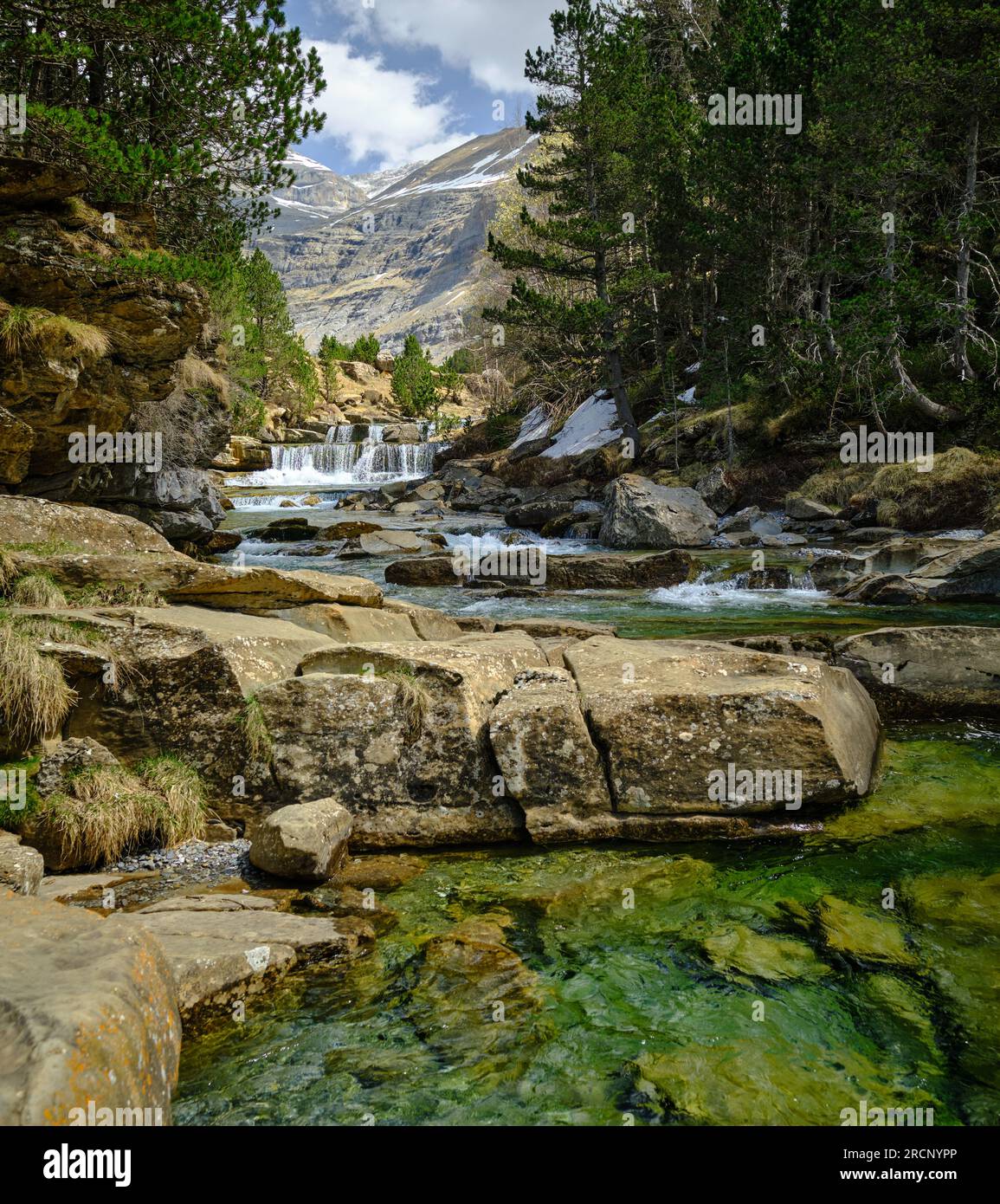 high mountain landscape in which waterfalls are seen through which a ...