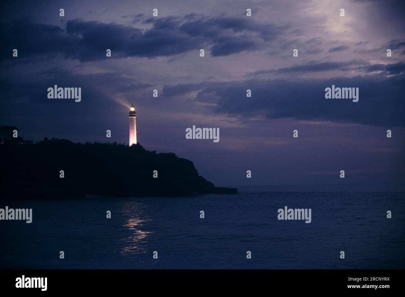long exposure of a night landscape, you can see a large lighthouse ...